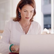 Design woman, typing and laptop in workshop with thinking, planning and ...