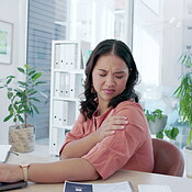 Asian woman, laptop and shoulder pain at office desk in discomfort ...