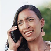 Phone call, argument and frustrated Indian woman in city in discussion ...