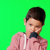 Moody, face and child in a studio with green screen with a upset, bad ...