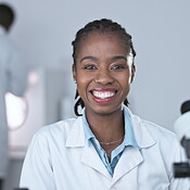 Black woman, scientist and face with smile and science study in ...