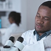 Black man scientist, laboratory microscope and shoulder pain of a ...