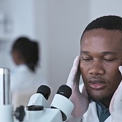Black man scientist, laboratory microscope and headache of a medical ...