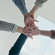 Team building, motivation and hands stacked from below at work for success, collaboration or ...