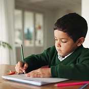 Boy, writing and learning with thinking, home and pencil for problem ...