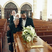 Funeral, church and people hug by coffin for goodbye, mourning and ...