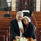 Funeral, church and couple hug by coffin for goodbye, mourning and ...