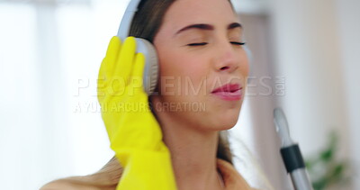 Woman, headphones and music while cleaning, singing along to radio and ...