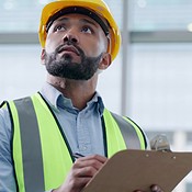 Building inspection, engineering and a construction worker with notes ...