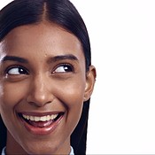Indian woman, face and smile with eyes or emoji for secret in beauty or ...