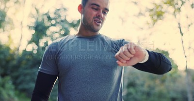 Fitness, watch and tired man in a forest for running, workout and ...