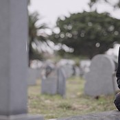 Sad woman, rose and graveyard in mourning, loss or grief at funeral ...