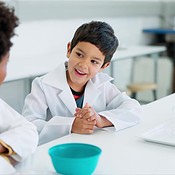 Education, science and children talking in class for a project, test or ...