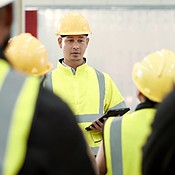 Factory, workers and group with manager in meeting with tablet for ...