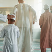 Muslim, child and men in a Mosque for spiritual religion together as a ...