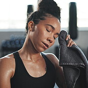 Tired, sweating and relax with woman in gym for breathing, workout and ...