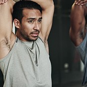 Men stretching at gym together for strong body, muscle development or ...