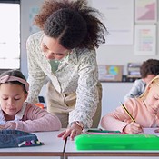 Help, teacher and woman in a classroom, students and education with ...