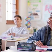 Education, study and student friends laughing in class while learning ...