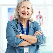Smile, crossed and face of senior doctor with confidence in her medical ...