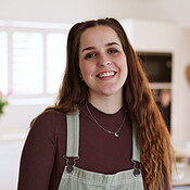 Face, smile and a woman influencer in her pottery studio for a live ...