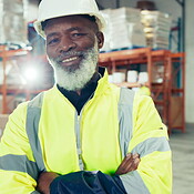 Warehouse, face and businessman cross arms for logistics, supply chain ...