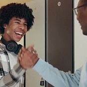 Handshake, flirting and students or friends in college campus laughing ...