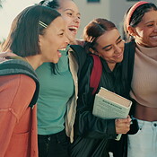 University, campus and group of students hug for support, care and on ...