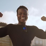 Face, outdoor and black man flexing arms, fitness and training with ...
