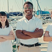 Man, women and ship with sailor team at port, travel and arms crossed ...