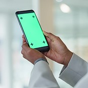 Phone, green screen and hand on woman in office with mockup for ...