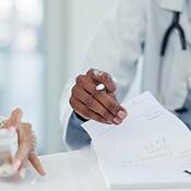 Hands, doctor and patient with pills, prescription note and health ...