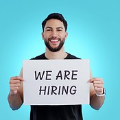 Recruitment, portrait and man in studio with sign, smile and job search ...