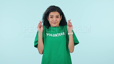 Volunteer, fingers crossed and portrait of a woman in studio for wish ...