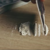 Cocaine, desk and lines of drugs with person and dollar bill for powder ...