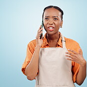 Woman, waitress and calling with smartphone, talking and blue studio ...