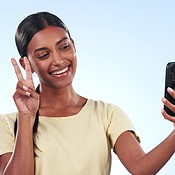 Happy woman, selfie and peace sign for photography, memory or social media against a studio ...