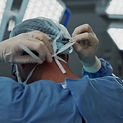 Surgery, hospital and doctor tie mask in operating room for medical ...