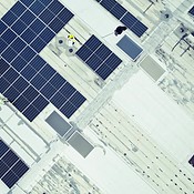 Overhead, solar energy and a design team on the roof of a building to ...