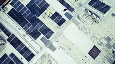 Overhead, solar energy and a design team on the roof of a building to ...