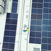 Overhead, solar energy and a construction team on the roof of a ...