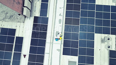 Overhead, solar energy and a construction team on the roof of a ...