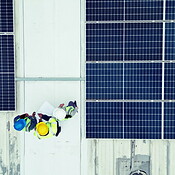 Overhead, solar power and an engineering team on the roof of a building ...