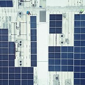 Overhead, solar energy and a construction worker team on a building ...