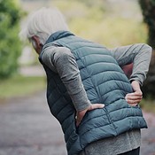 Old woman, back pain and fitness injury outdoor, spine and workout with ...