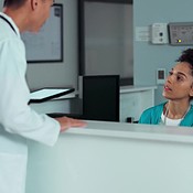 Receptionist, doctor paperwork and hospital people, nurse or surgeon ...