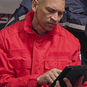 Tablet, paramedic and a man in an ambulance for emergency service or ...
