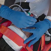 Emergency service, paramedic and hands with a light for a woman ...