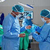 Surgeon mask, gloves and nurse help with dressing, preparation and ...