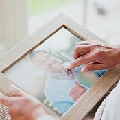 Photo frame, hands and senior person in a retirement and nursing home with picture. Thinking ...